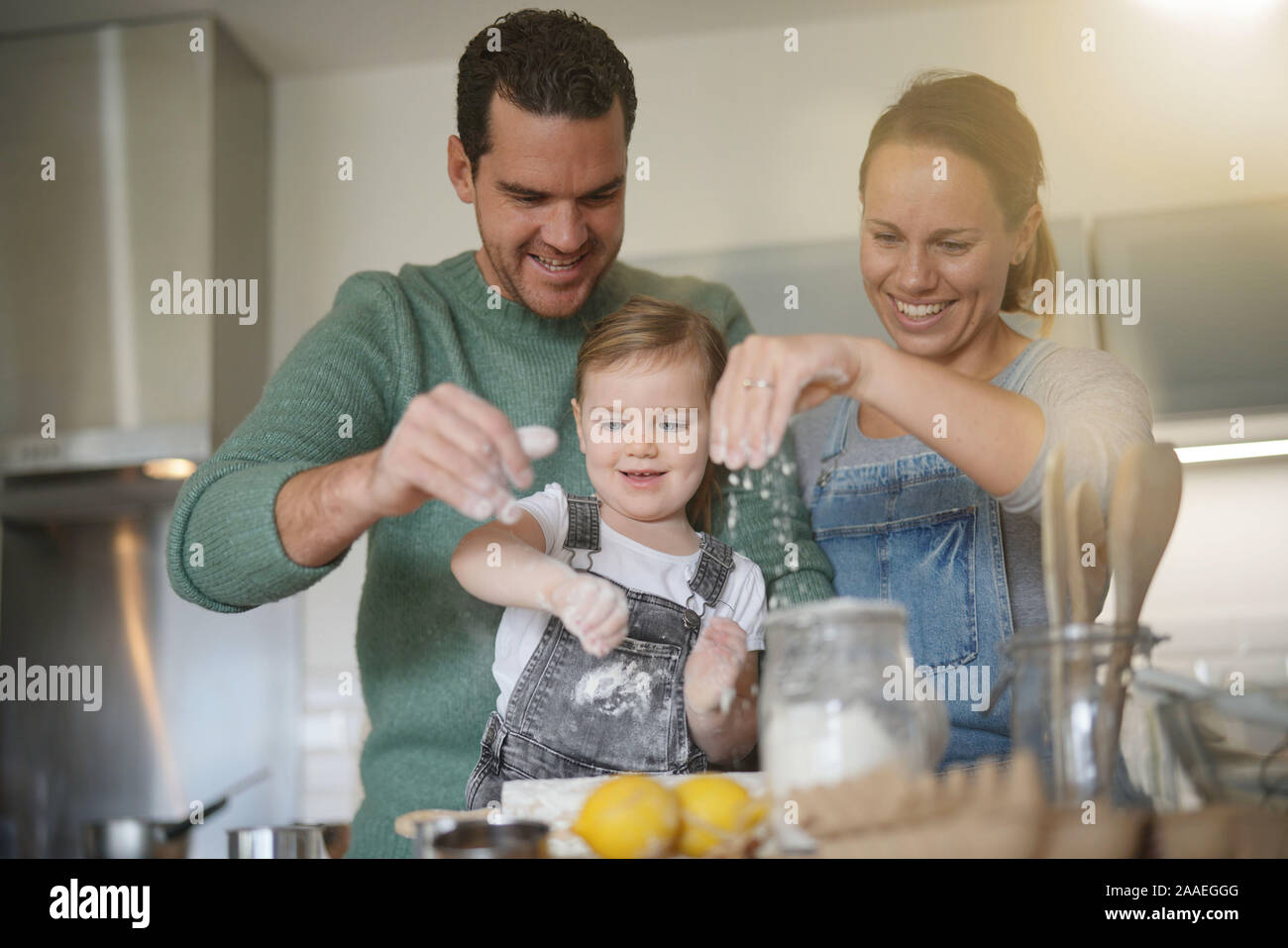 Happy family baking together Stock Photo - Alamy