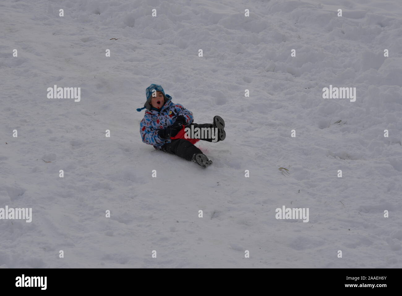 Fall of little boy in sledge Mercury Savoie Stock Photo - Alamy