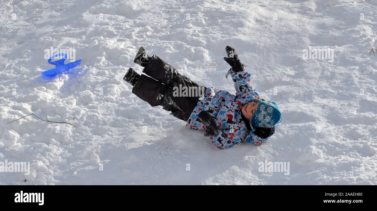 Fall of little boy in sledge Mercury Savoie Stock Photo - Alamy