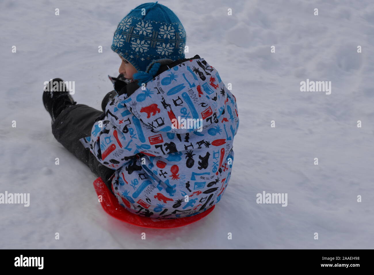 Fall of little boy in sledge Mercury Savoie Stock Photo - Alamy