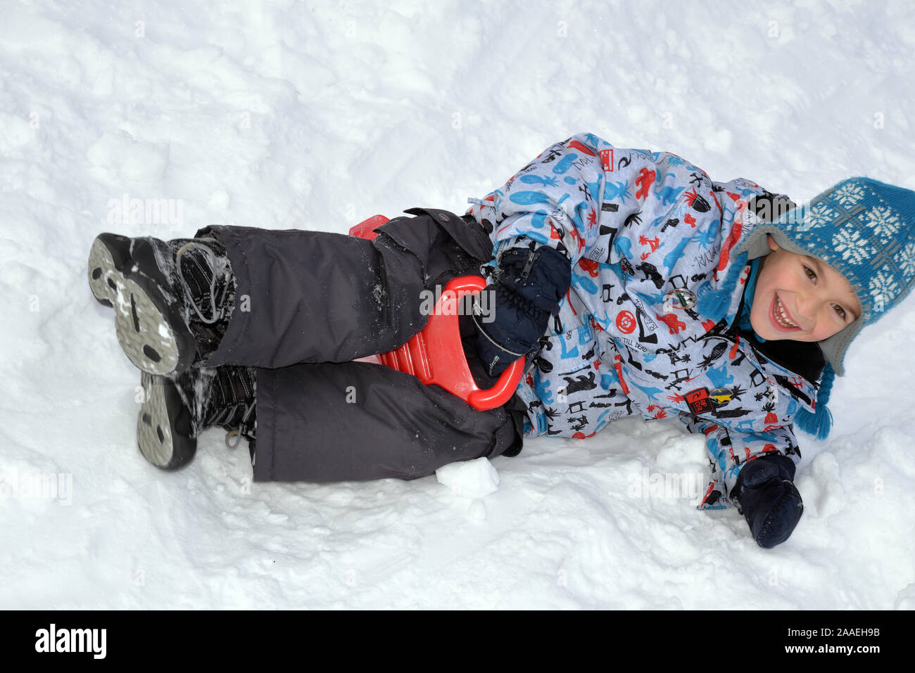Fall of little boy in sledge Mercury Savoie Stock Photo - Alamy