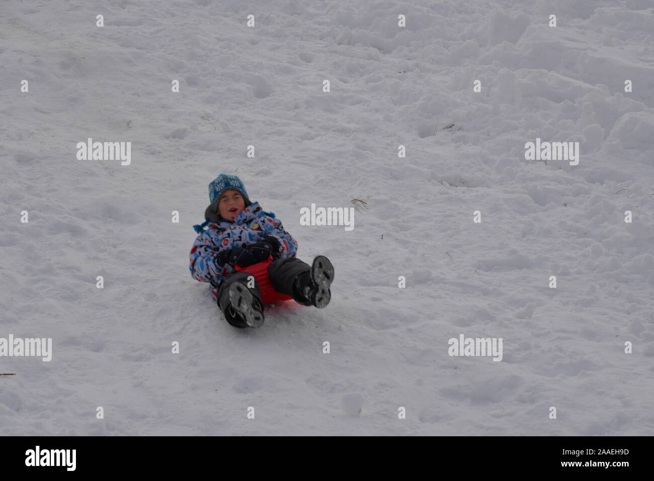 Fall of little boy in sledge Mercury Savoie Stock Photo - Alamy