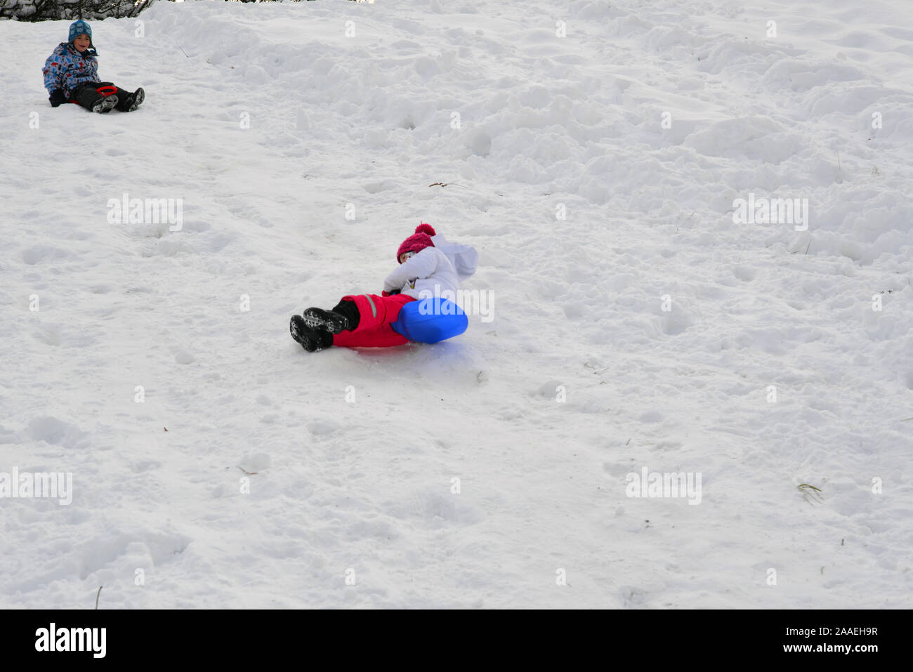 Fall of little girl in sledge Mercury Savoie Stock Photo - Alamy