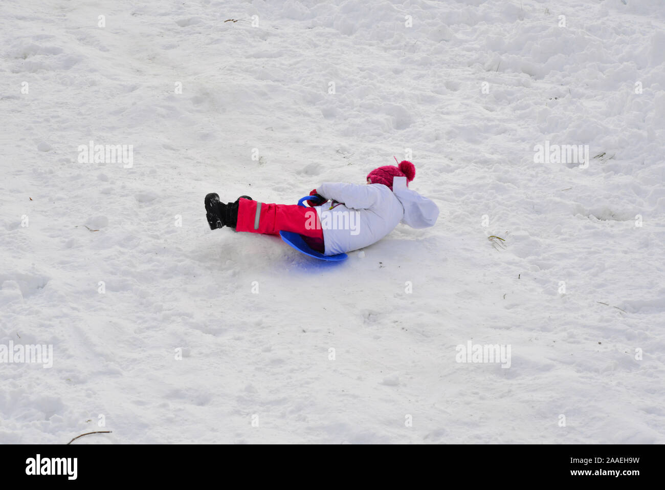 Fall of little girl in sledge Mercury Savoie Stock Photo - Alamy