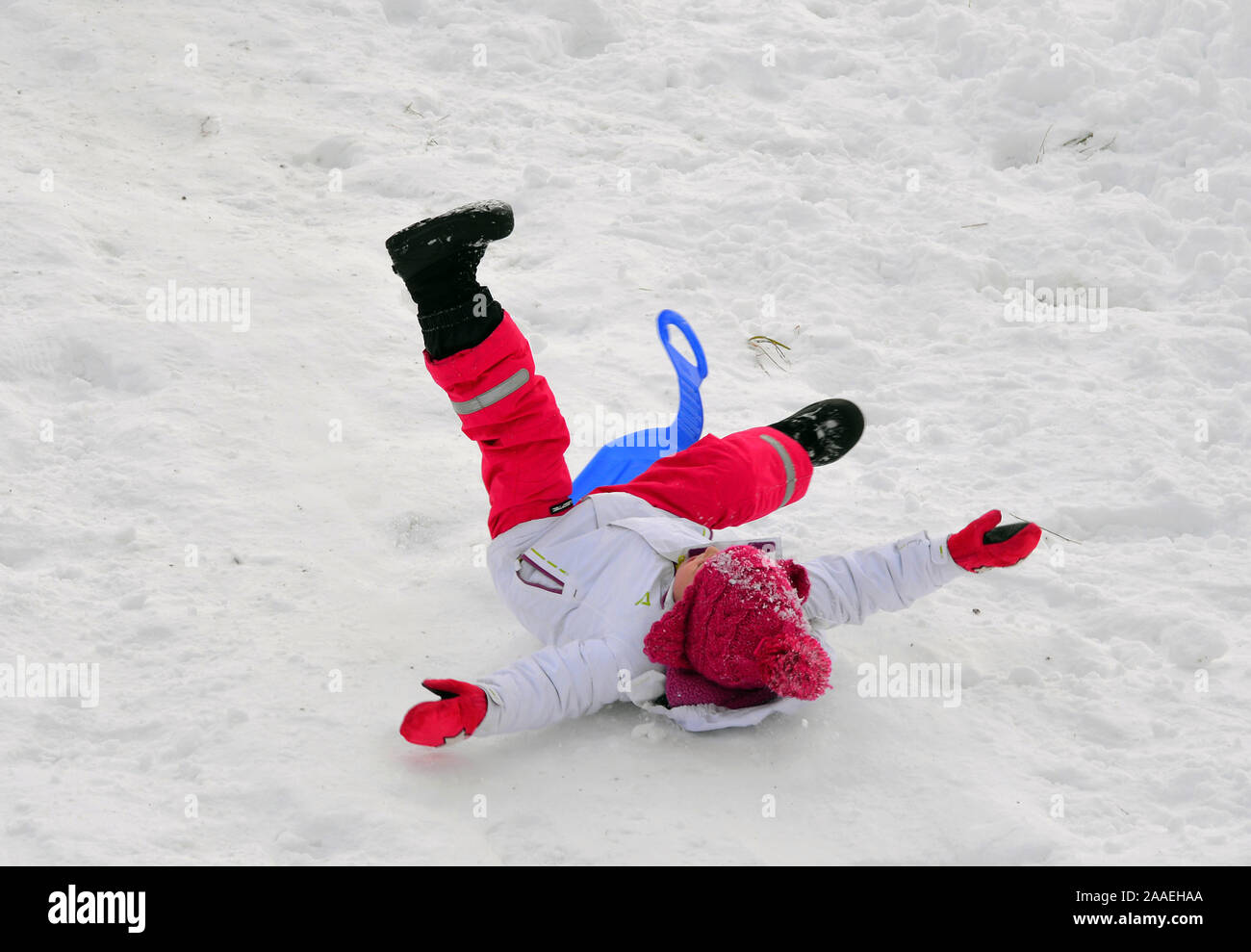 Fall of little girl in sledge Mercury Savoie Stock Photo - Alamy