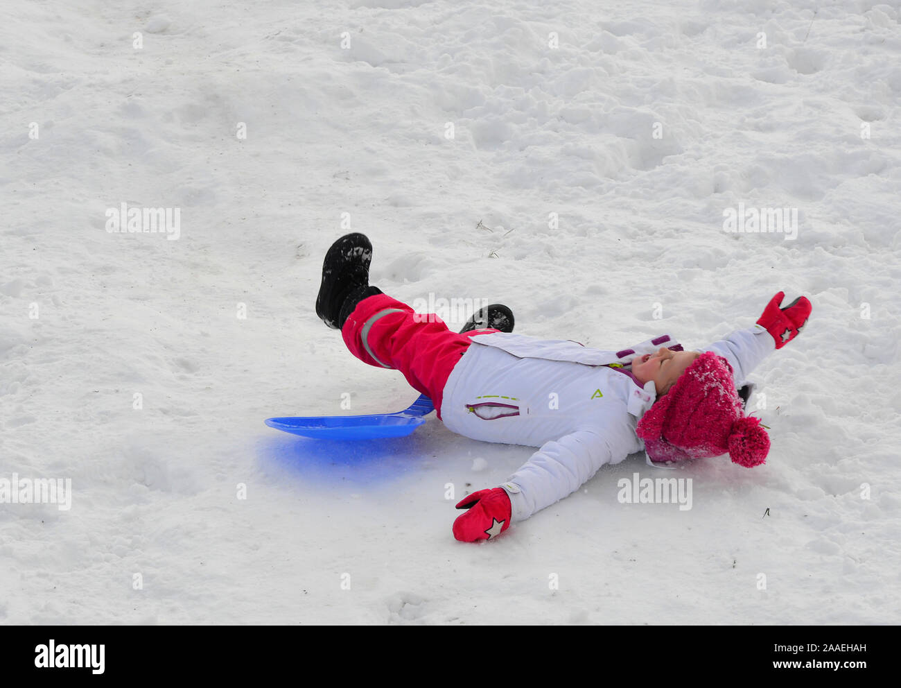 Fall of little girl in sledge Mercury Savoie Stock Photo - Alamy
