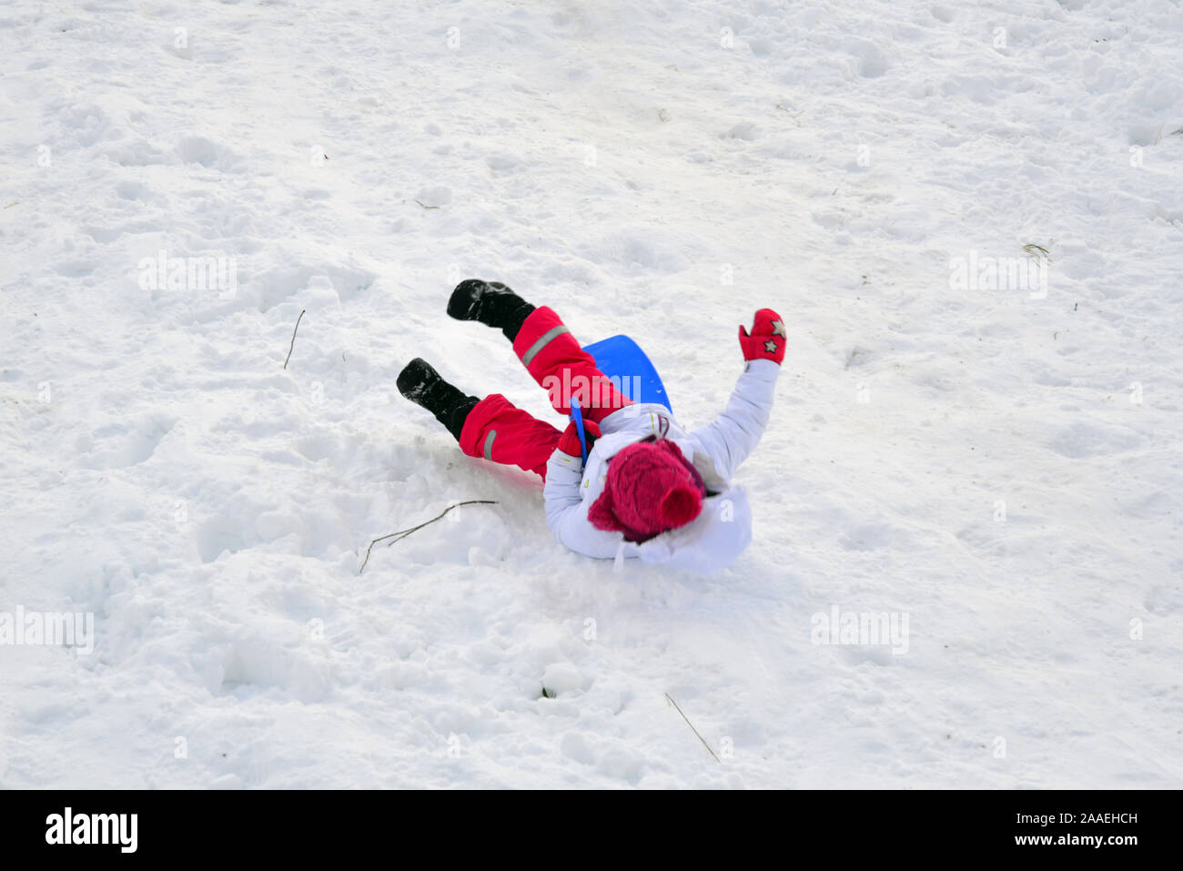 Fall of little girl in sledge Mercury Savoie Stock Photo - Alamy