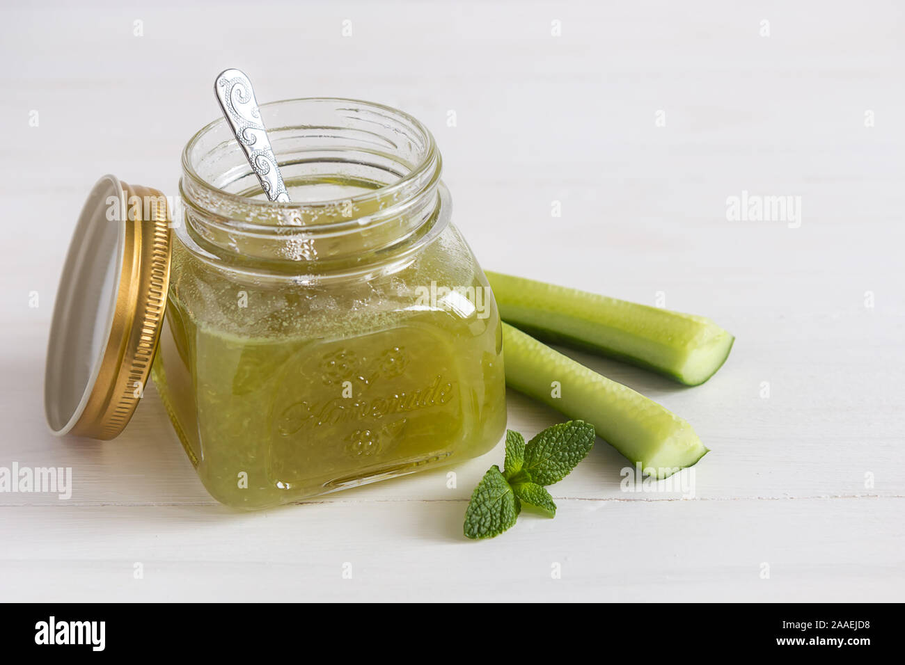 Vegetable cucumber jam in a glass jar on a white background. Horizontal ...