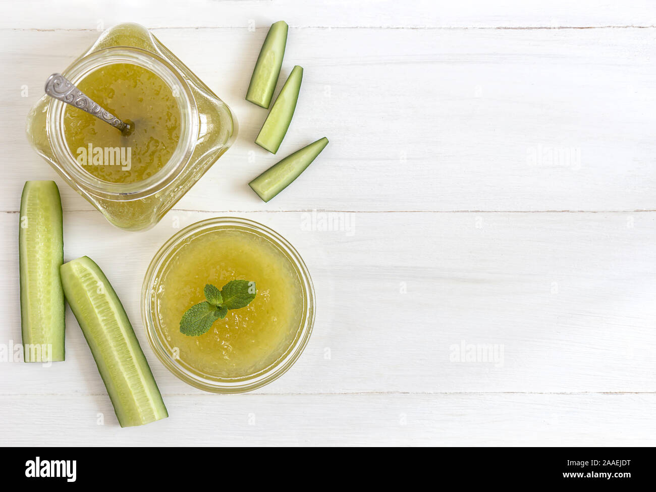 Vegetable green cucumber jam on a white background. Flat lay with copy ...