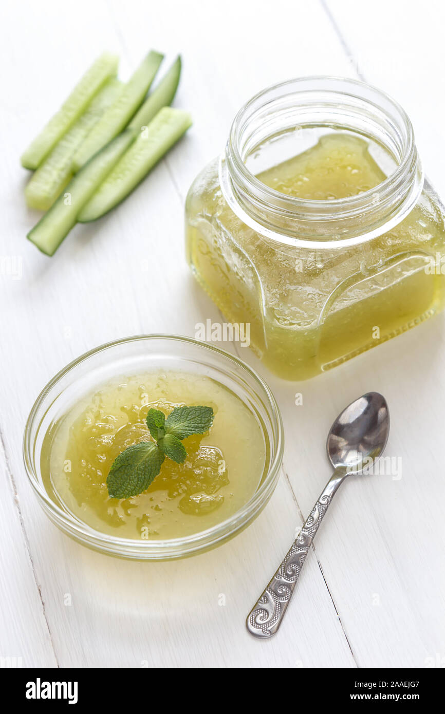 Cucumber vegetable jam in a glass bowl on a white background. Vertical ...