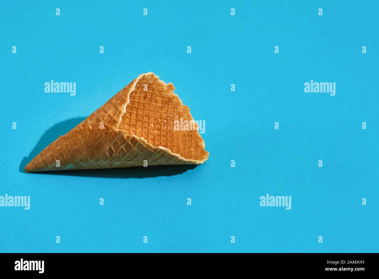 Waffle ice cream cones with shadow on a blue background Stock Photo - Alamy