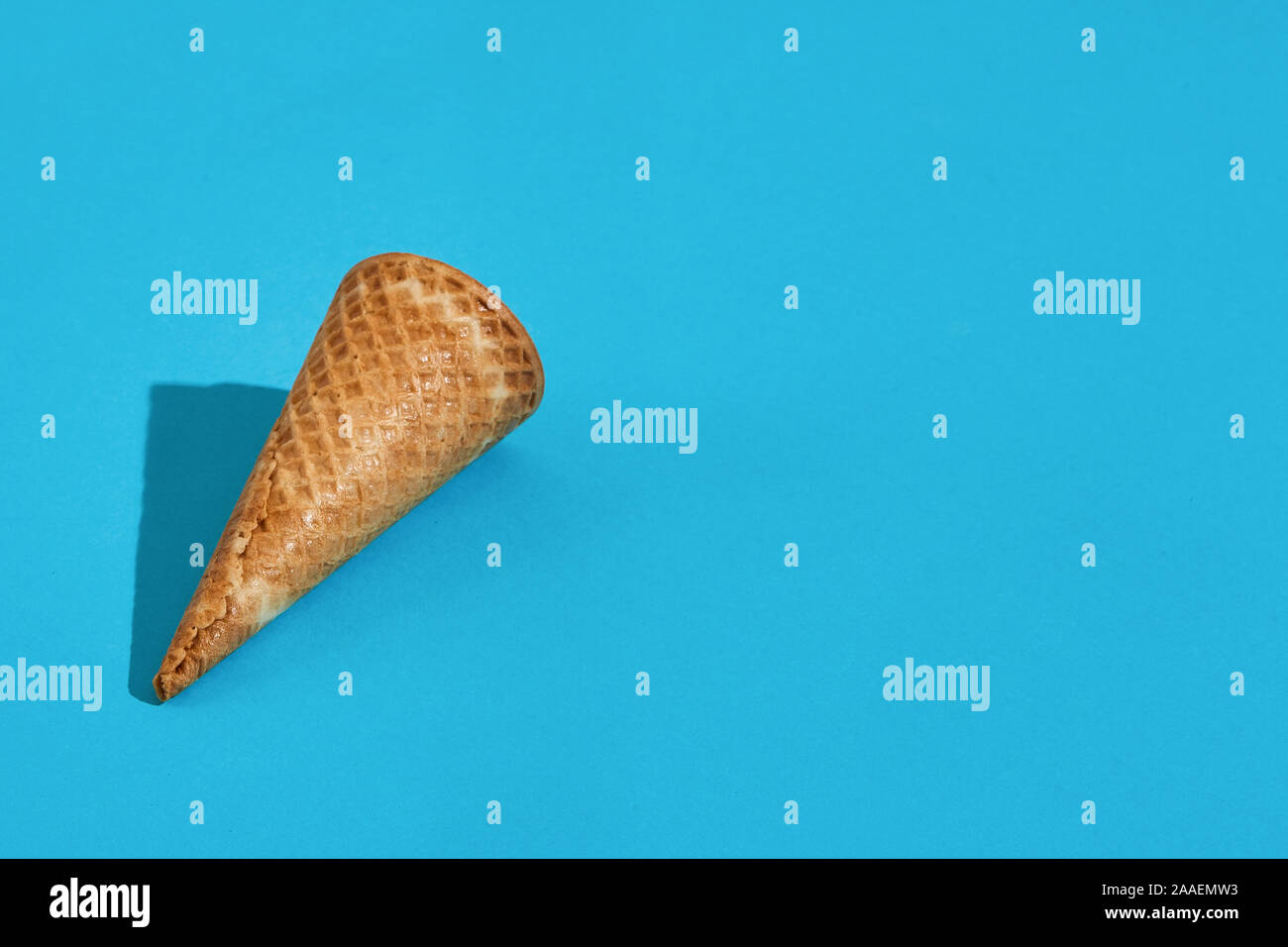 Waffle ice cream cones with shadow on a blue background Stock Photo - Alamy