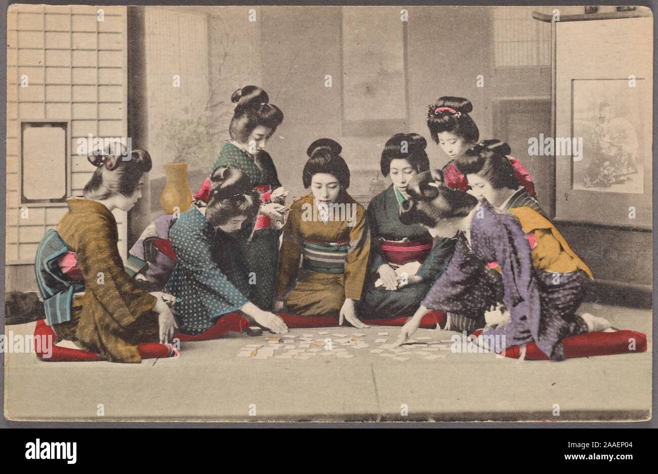 Illustrated postcard of a group of Japanese young women dressed in traditional clothing kneeling ...