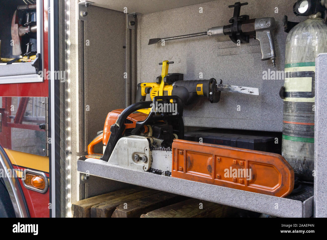 Fire truck compartment with chainsaw and other tools Stock Photo - Alamy