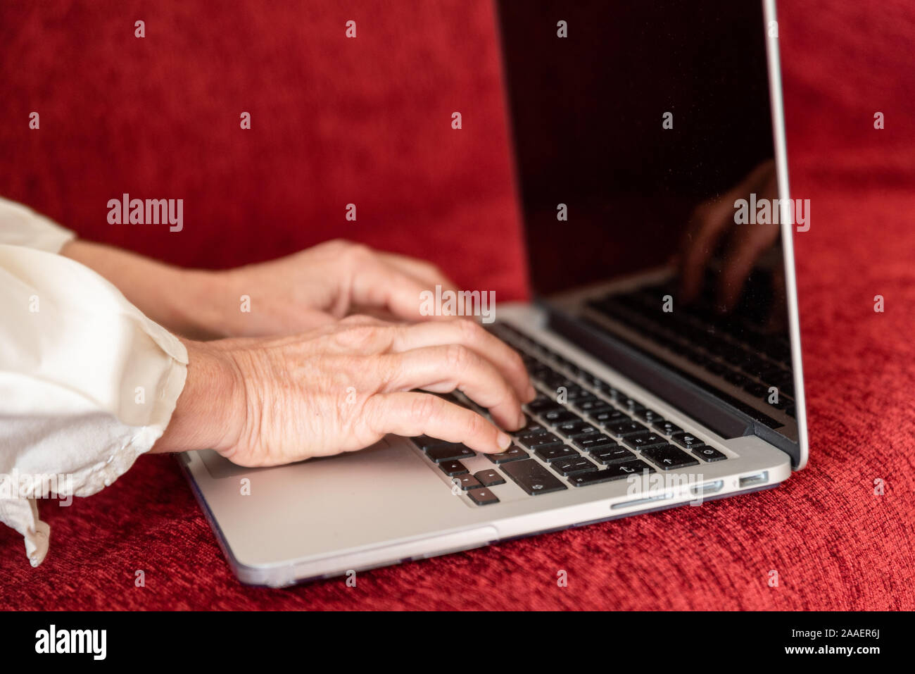 Hands of mature woman using computer at home, top view Stock Photo - Alamy