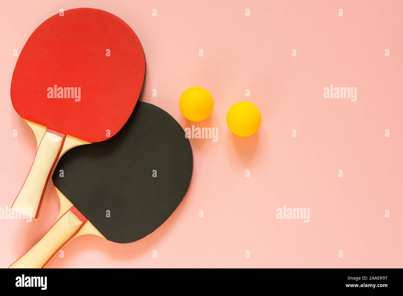 Black and red tennis ping pong rackets and orange balls isolated on a ...