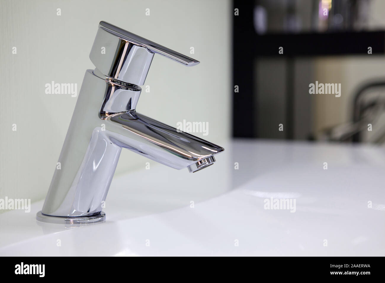 Shiny water tap faucet on bathroom sink Stock Photo - Alamy