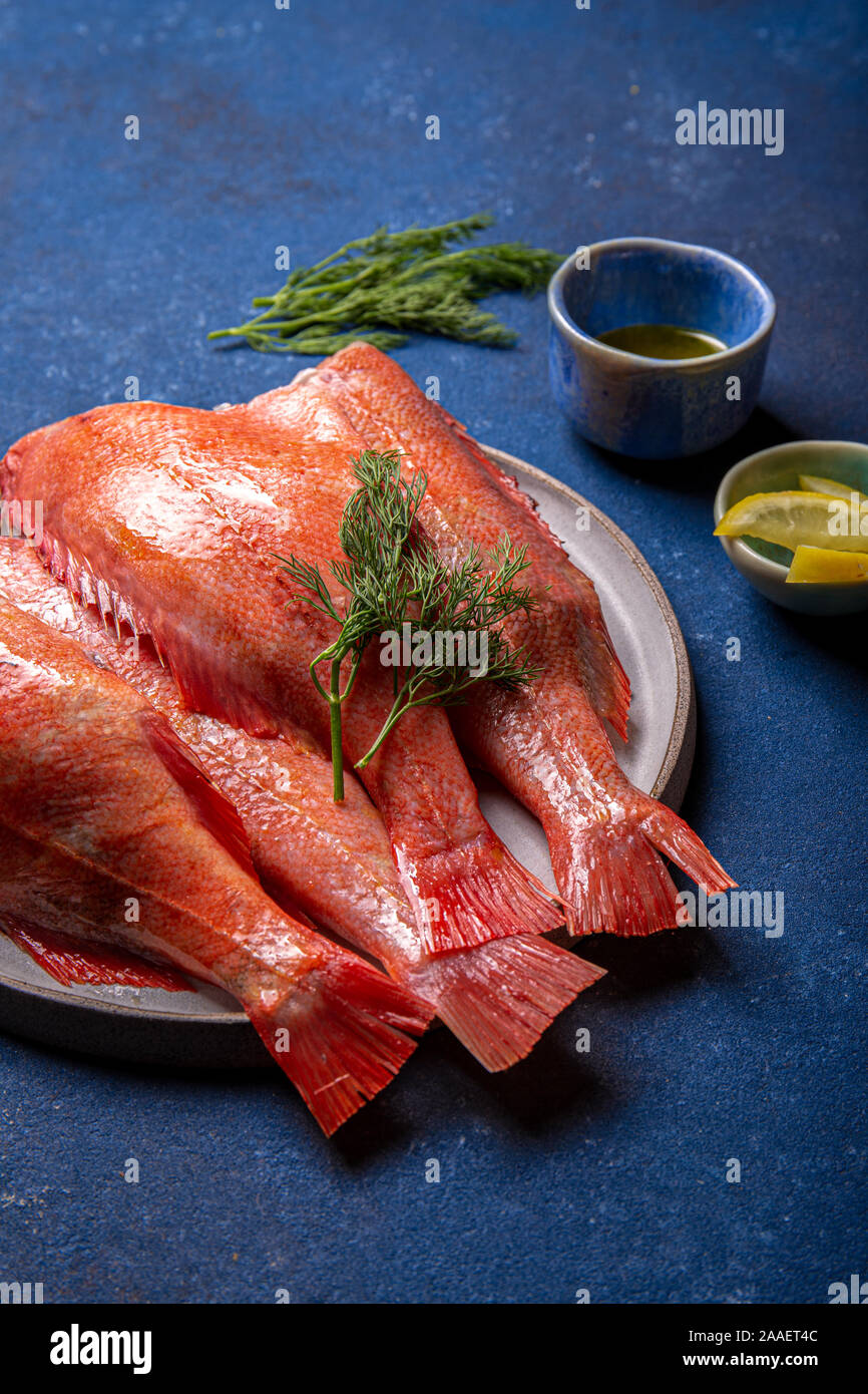 Fresh red sea bass on blue background. Top view, copy space Stock Photo ...