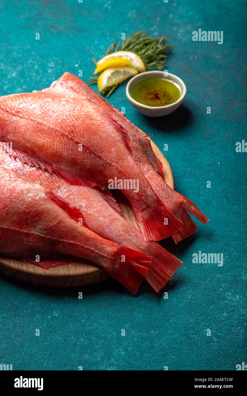 Fresh red sea bass on blue background. Top view, copy space Stock Photo ...