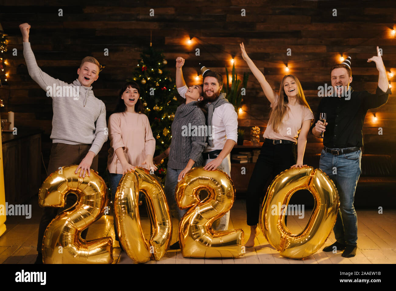 Bunch of happy friends are holding inflatable foil numerals 2020 Stock ...