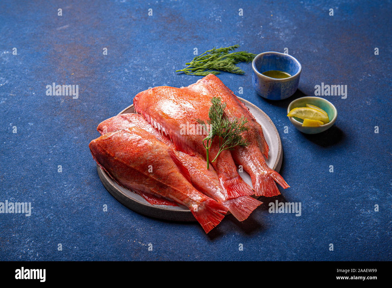 Fresh red sea bass on blue background. Top view, copy space Stock Photo ...