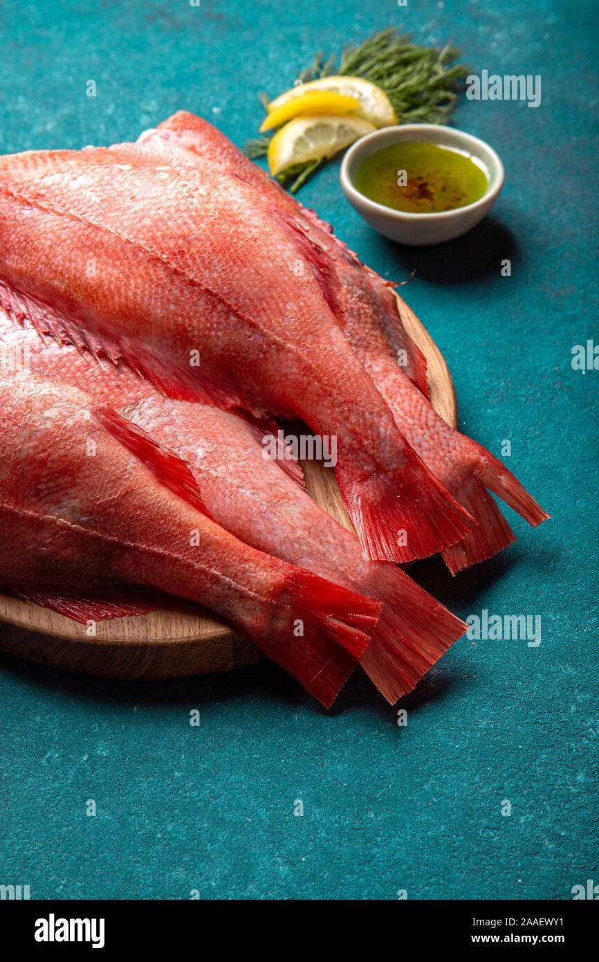 Fresh red sea bass on blue background. Top view, copy space Stock Photo ...