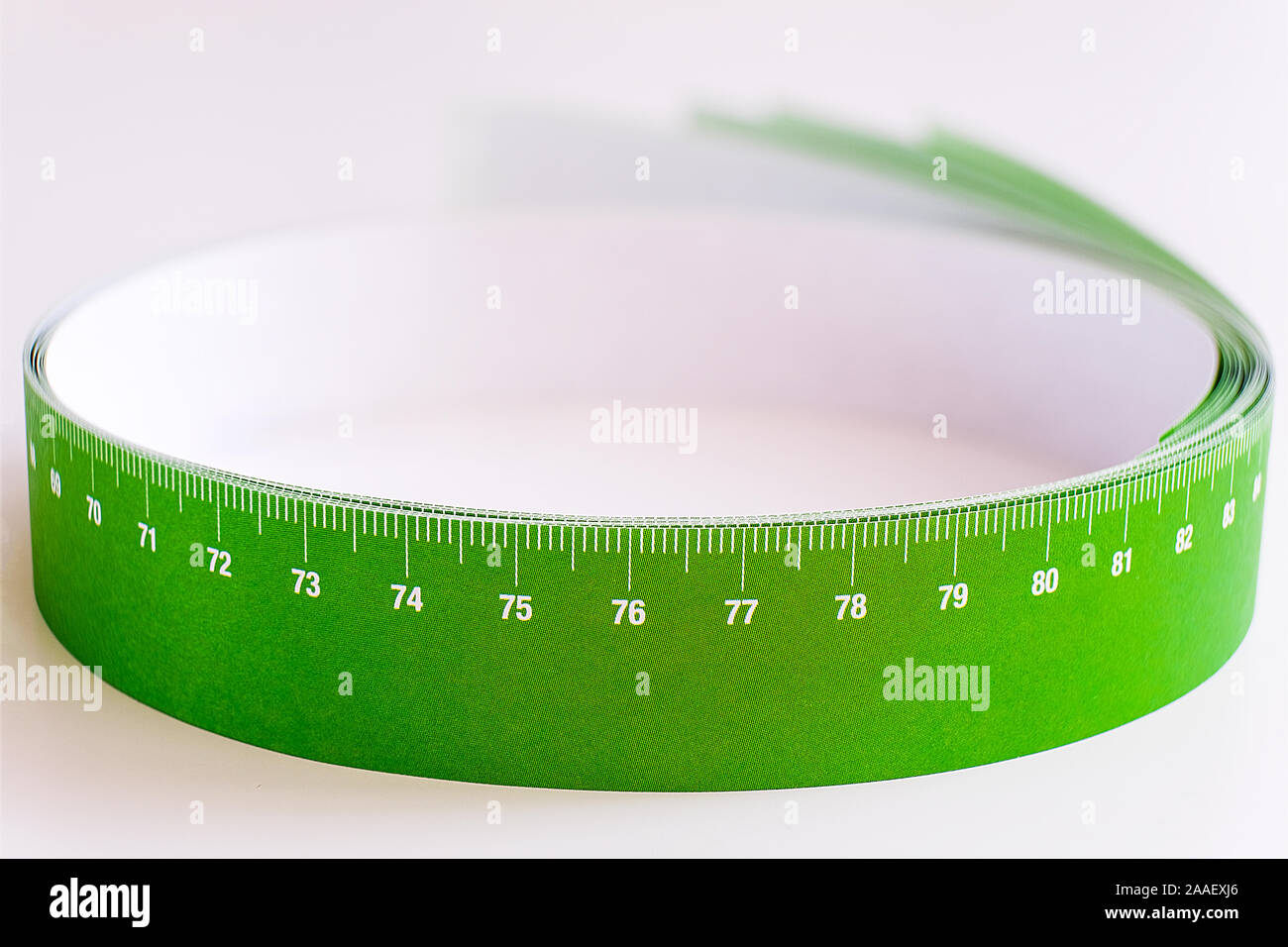 Meter tape for measuring rolled into a roll, on a light background ...