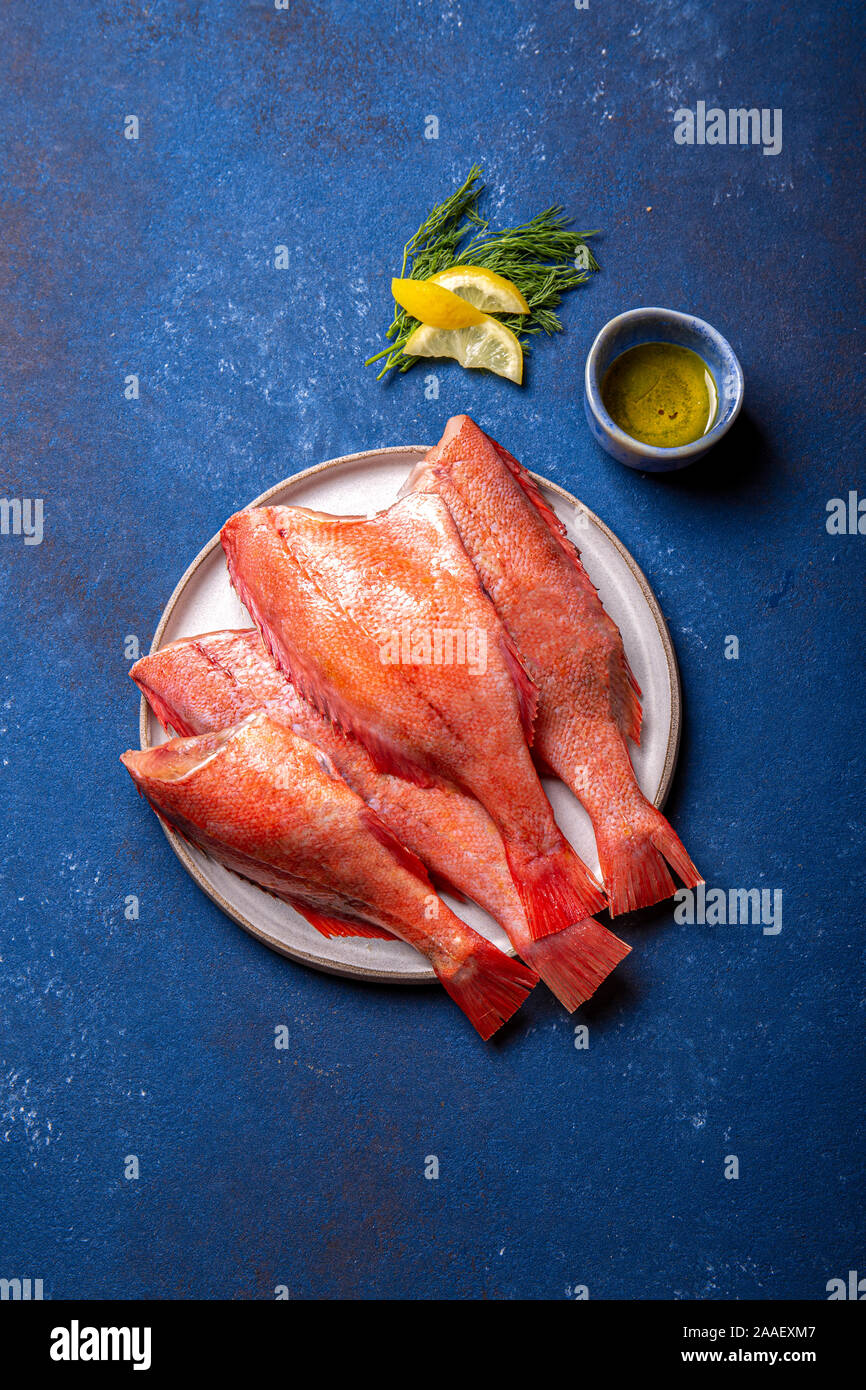 Fresh red sea bass on blue background. Top view, copy space Stock Photo ...