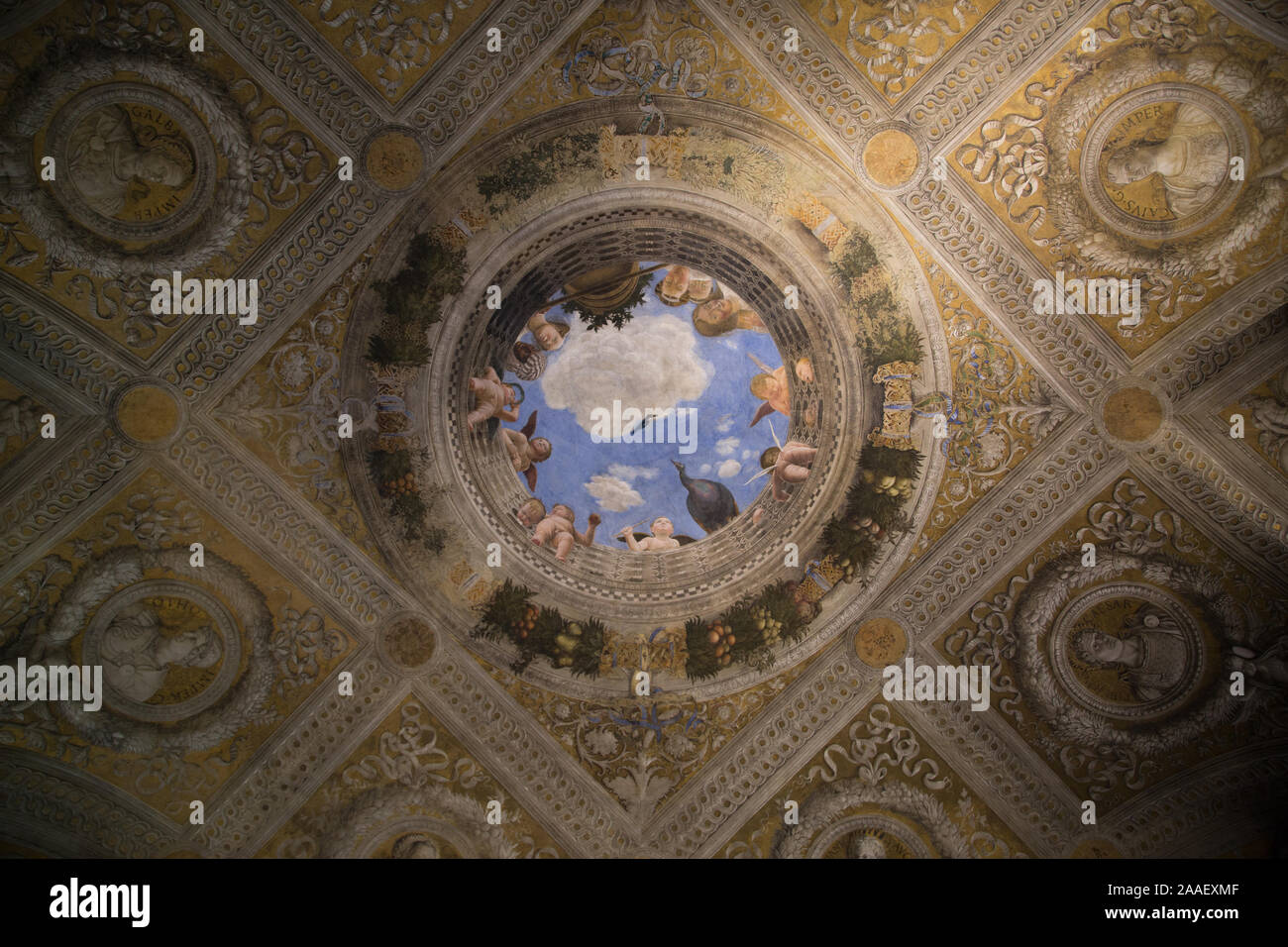 A ceiling mural of angels peering down from heaven within the Palazzo ...