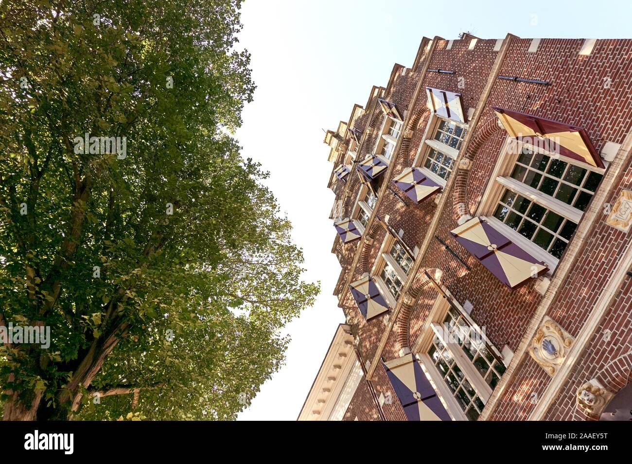 Low view on facade of historic dutch house with window shutters and ...