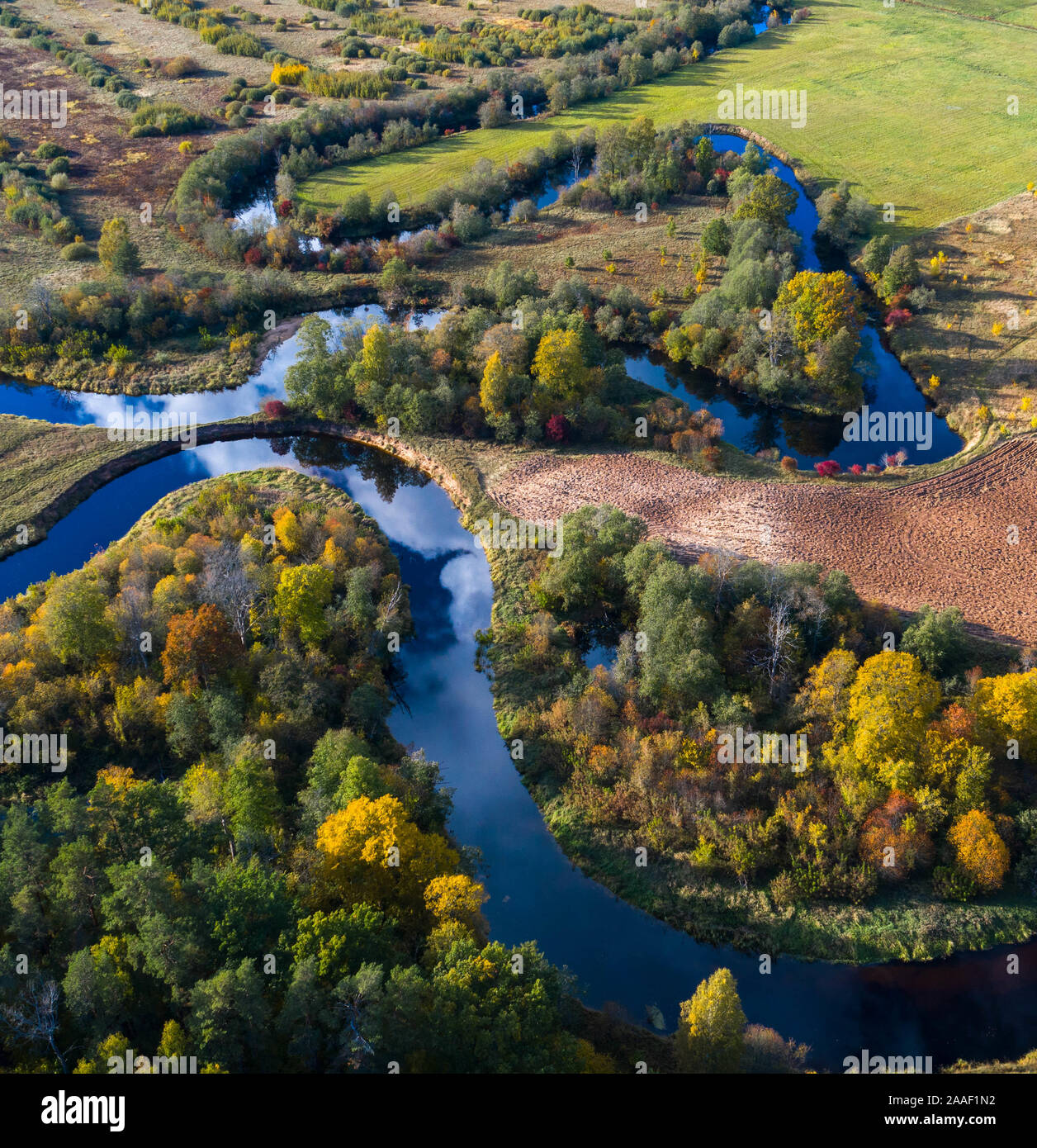 Beautiful autumn landscape. View from above. River Jugla, field and ...