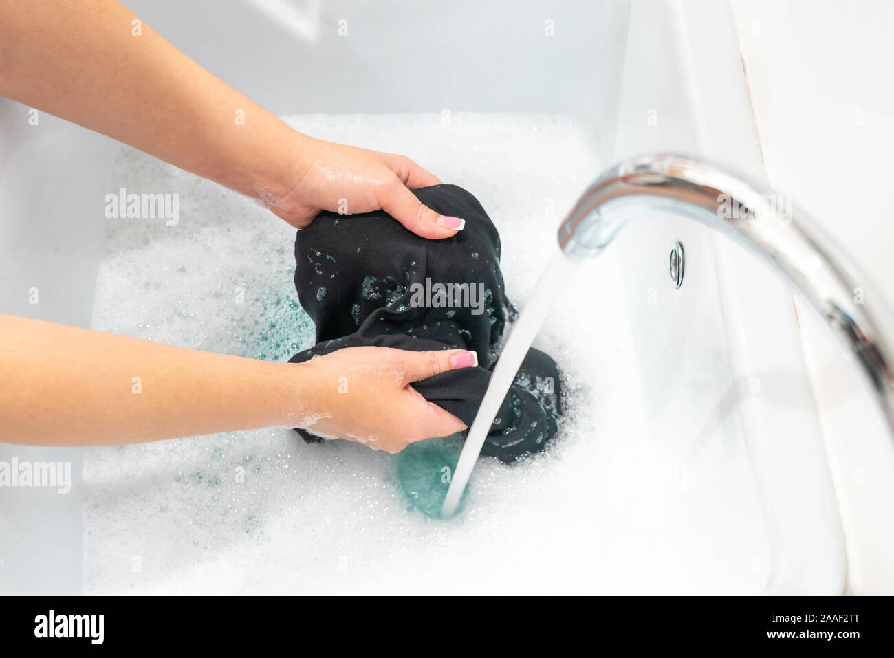 Clothes in basin hi-res stock photography and images - Alamy