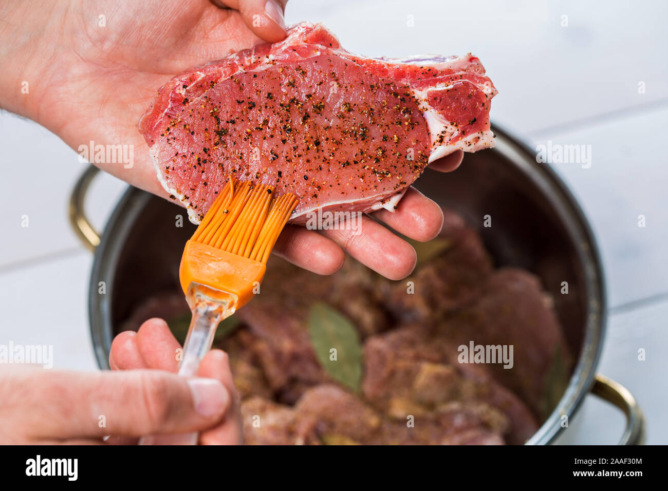 Close up of chefs hands spicing the meat Stock Photo - Alamy