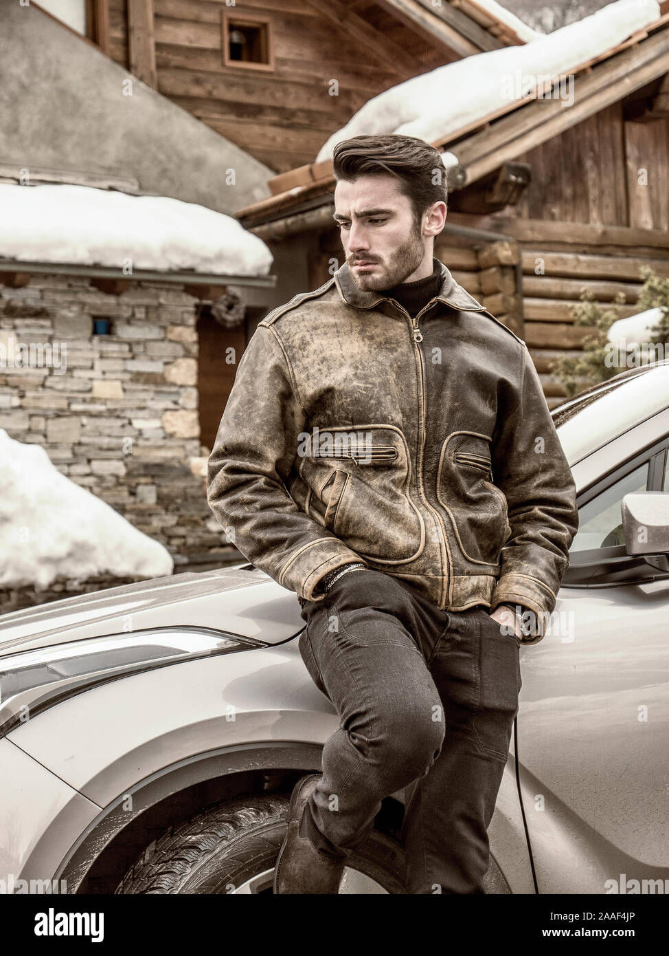 Young man standing leaning on SUV car Stock Photo - Alamy