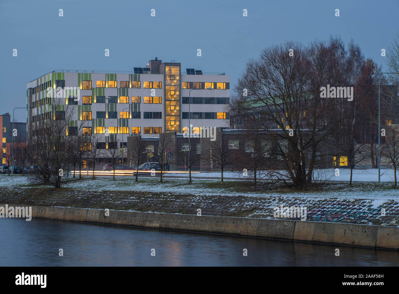 Modern design of office building. Modern architecture in twilight. Snow ...