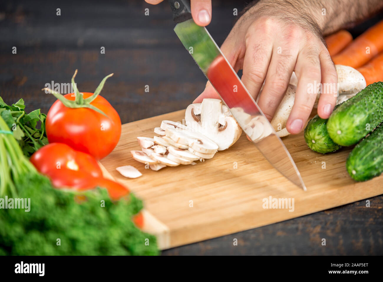 Male hands cutting vegetables for salad Stock Photo - Alamy