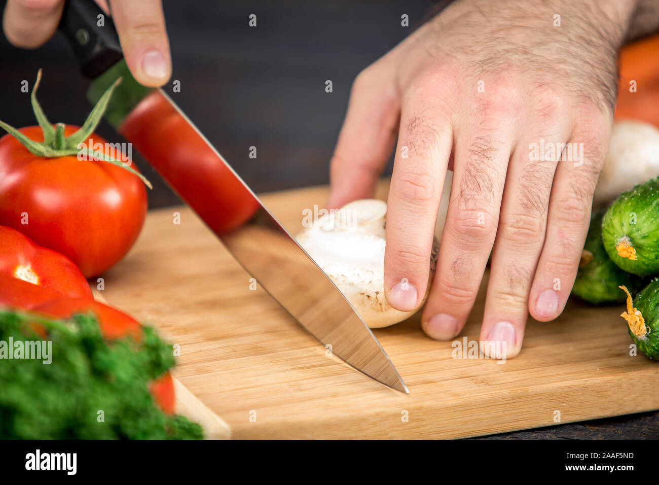 Male hands cutting vegetables for salad Stock Photo - Alamy