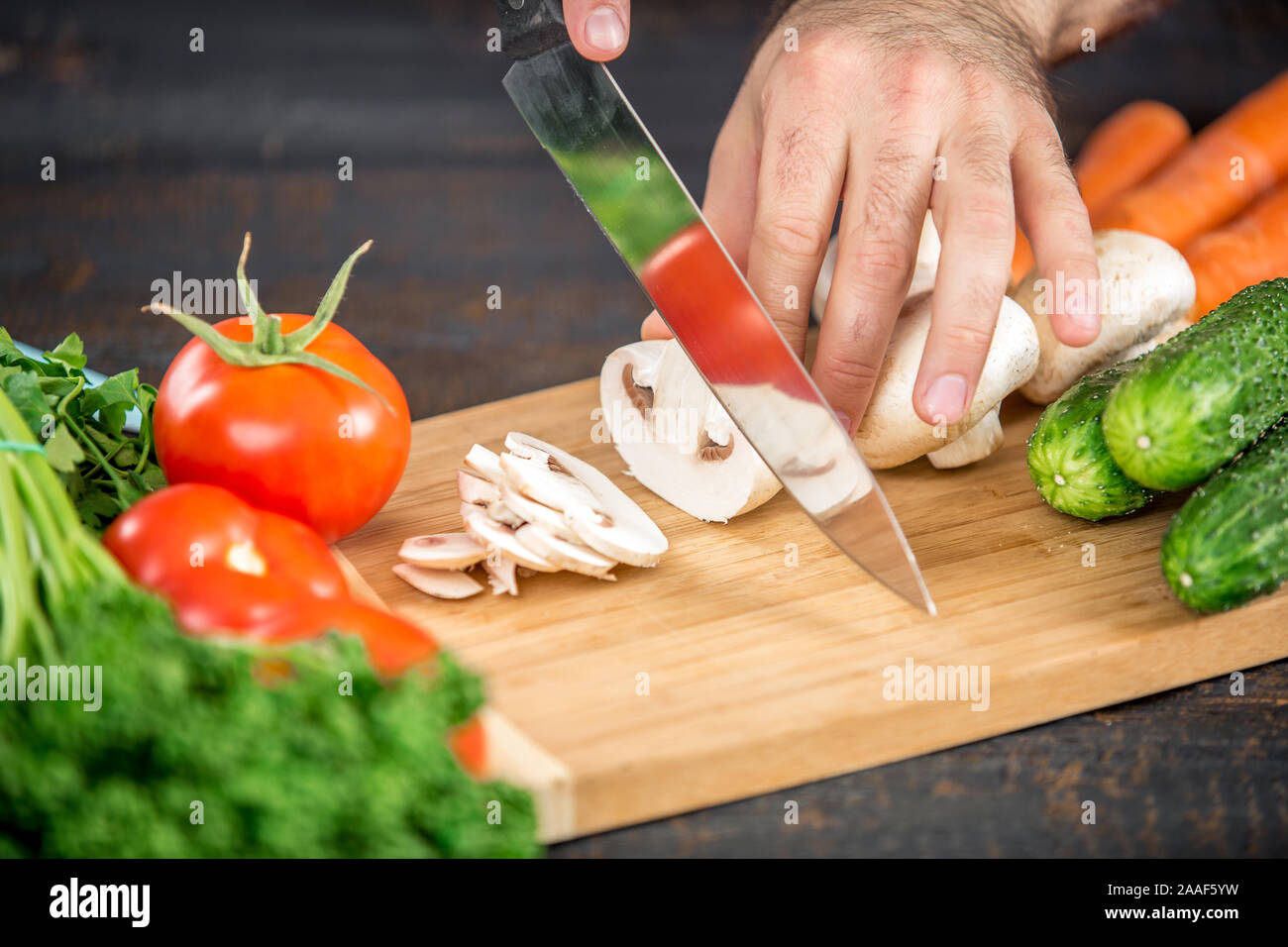 Male hands cutting vegetables for salad Stock Photo - Alamy