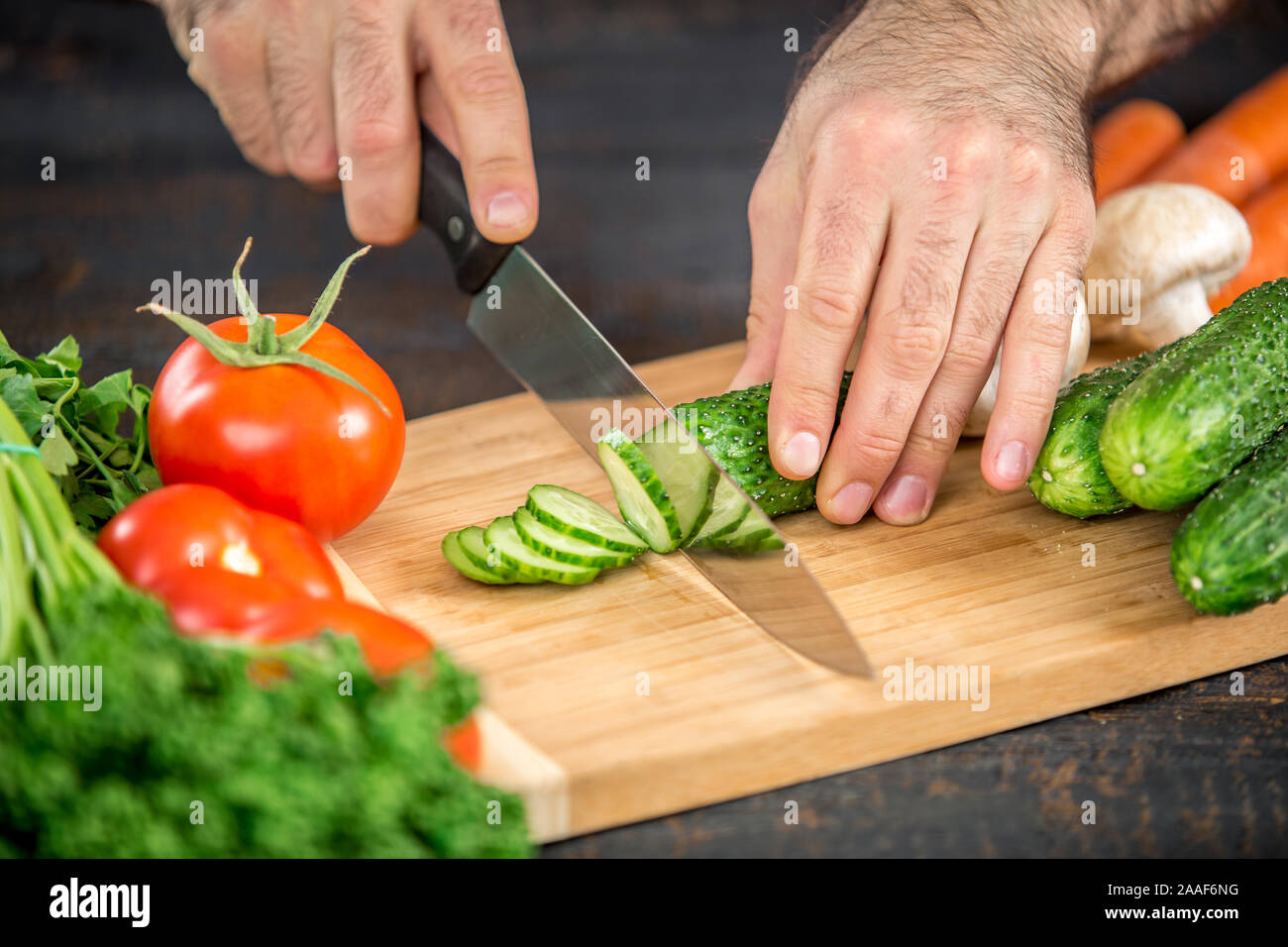 Male hands cutting vegetables for salad Stock Photo - Alamy