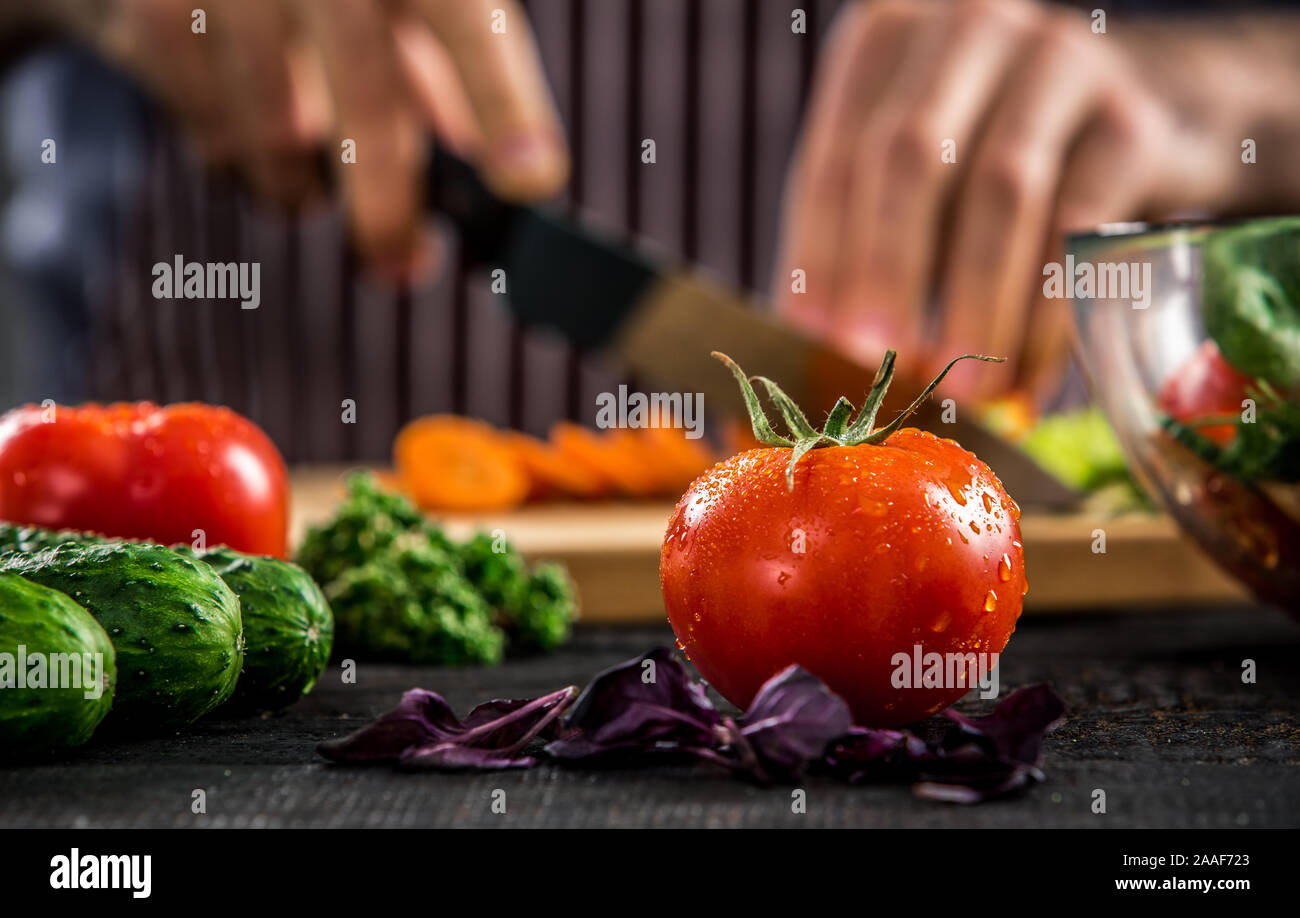 Male hands cutting vegetables for salad Stock Photo - Alamy