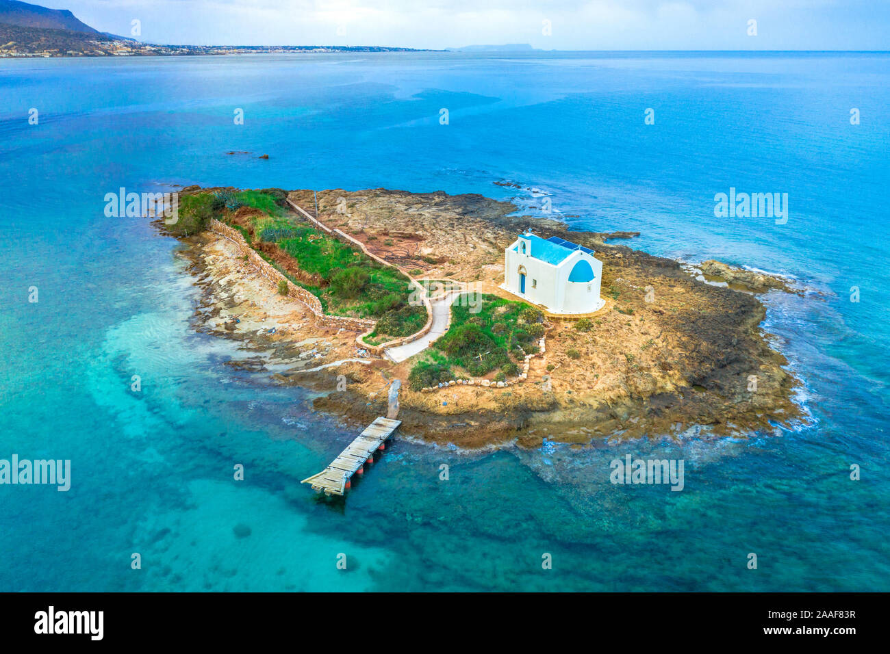 An old white church in a small island at sunset in Malia, Crete, Greece ...