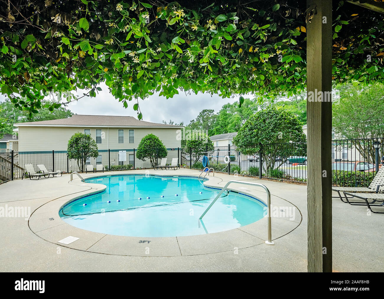 The swimming pool features an outdoor seating area with a covered ...