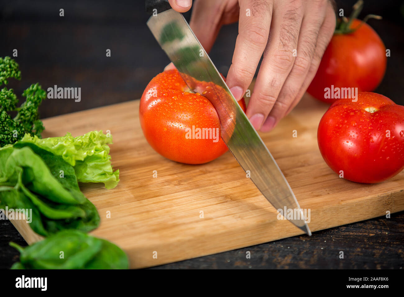 Male hands cutting vegetables for salad Stock Photo - Alamy