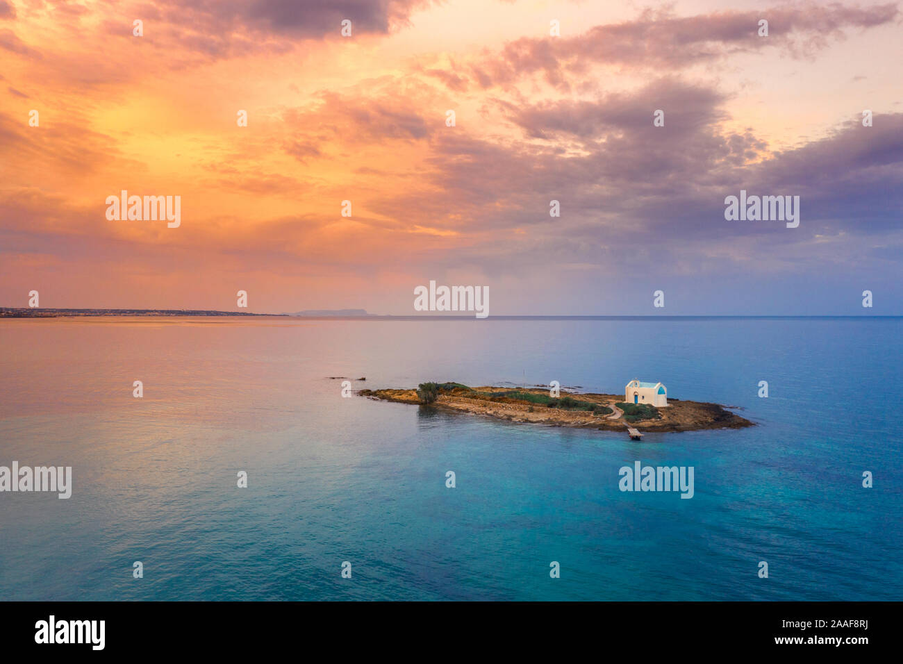 An old white church in a small island at sunset in Malia, Crete, Greece ...