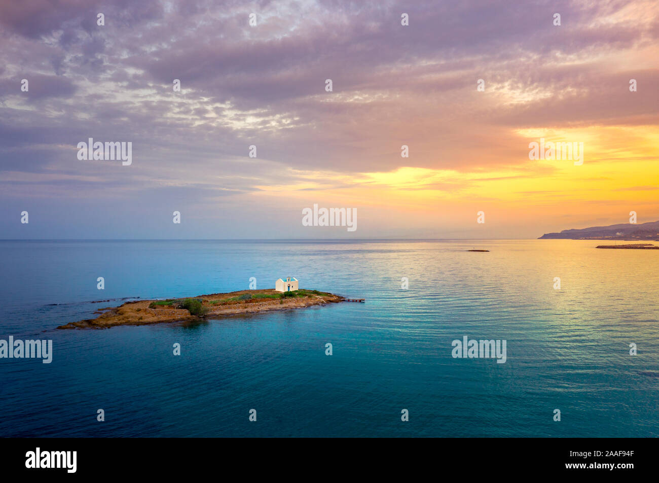 An old white church in a small island at sunset in Malia, Crete, Greece ...