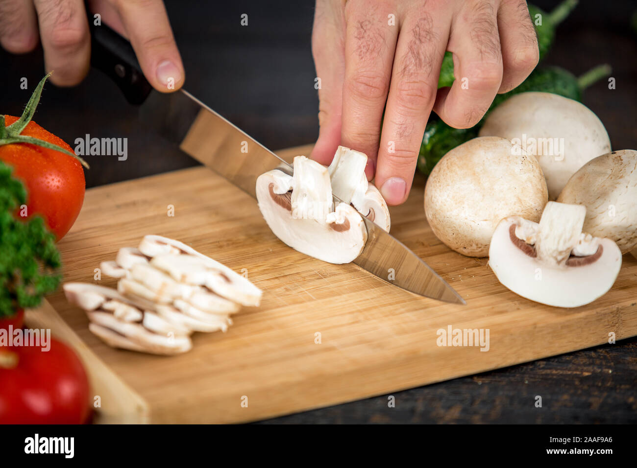 Male hands cutting vegetables for salad Stock Photo - Alamy