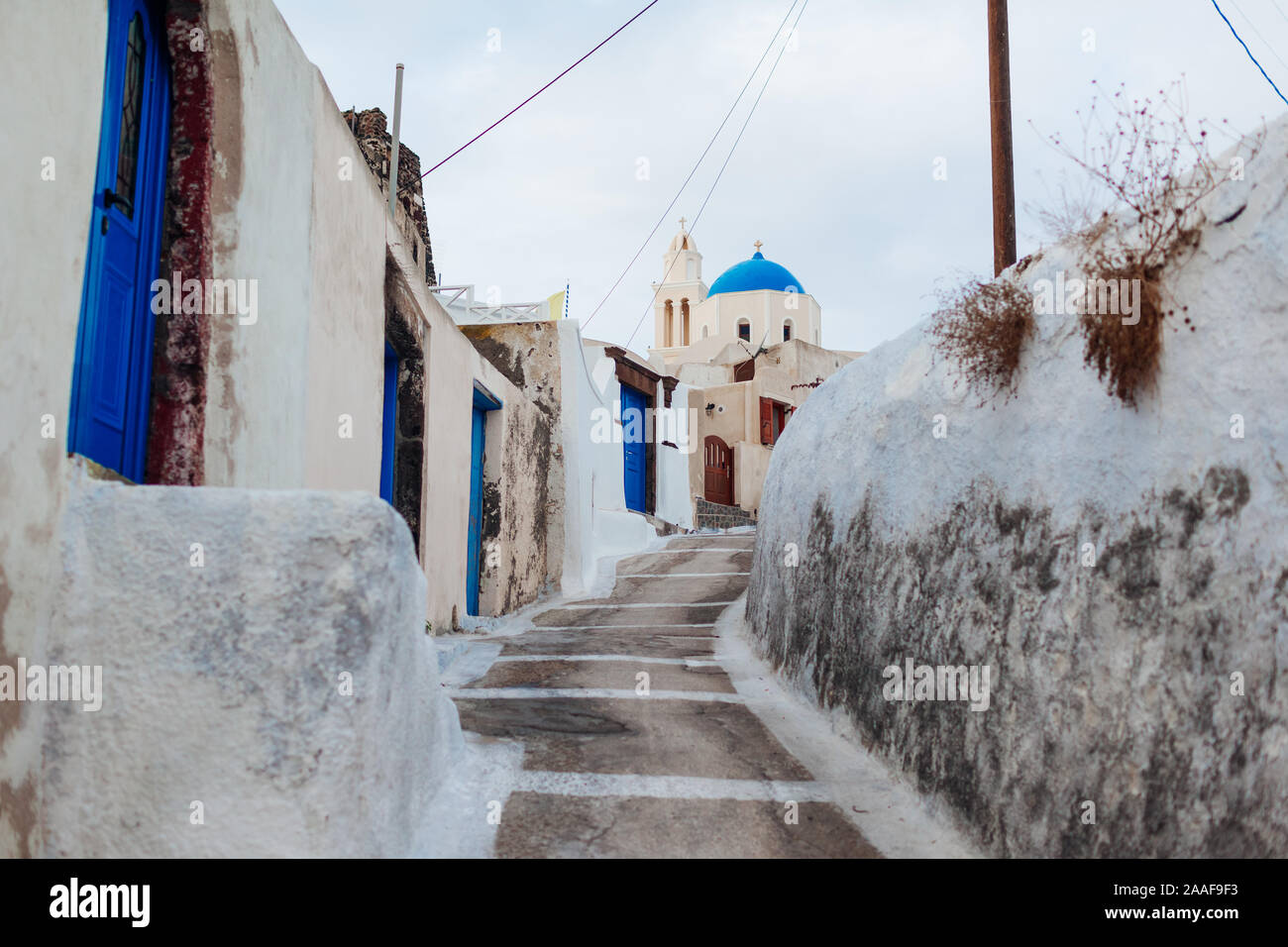 Typical street in Akrotiri village on Santorini island, Greece. White ...