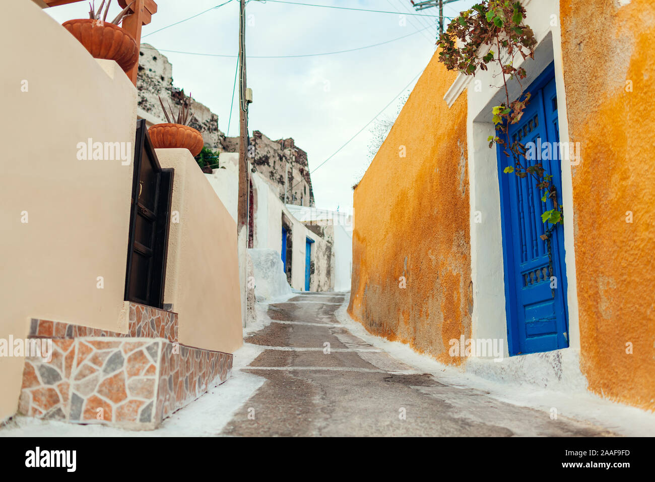 Old street in Akrotiri village on Santorini island, Greece. View of ...