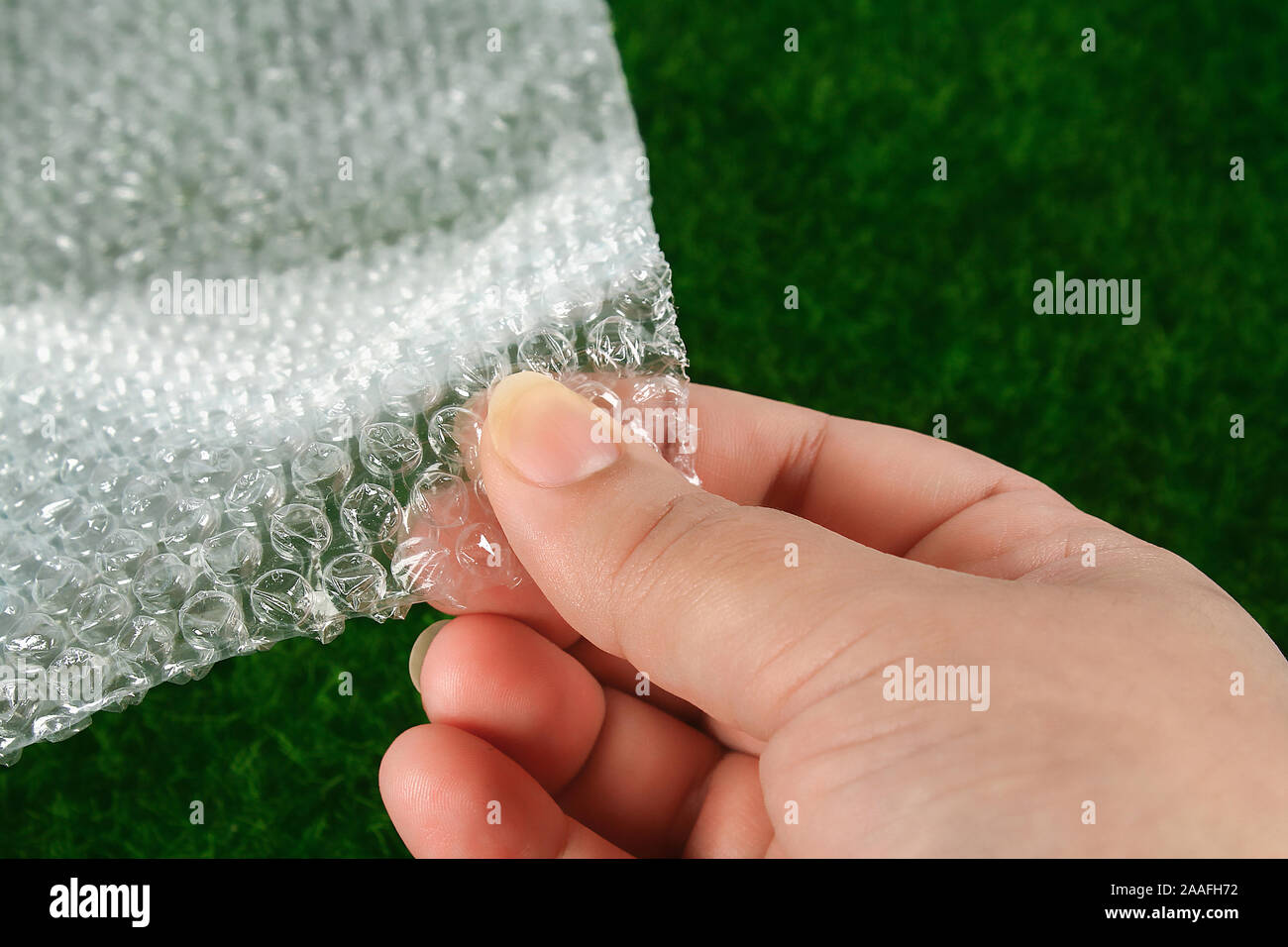 The hand touches the bubble wrap. The concept of touch, tactility ...