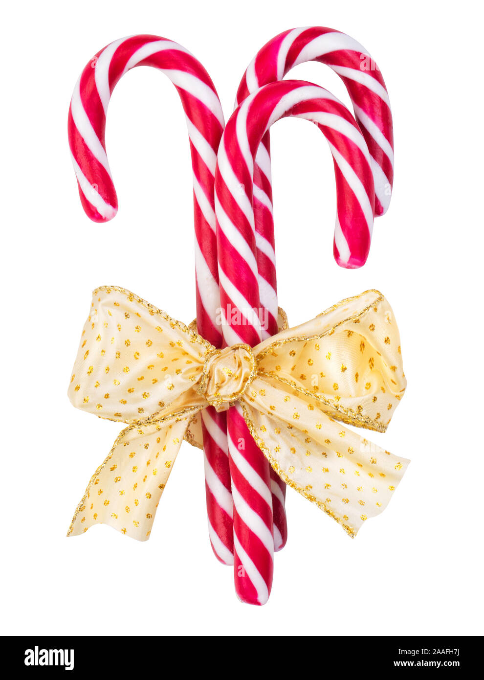 Red striped caramel sticks tied with a golden bow isolated on white ...